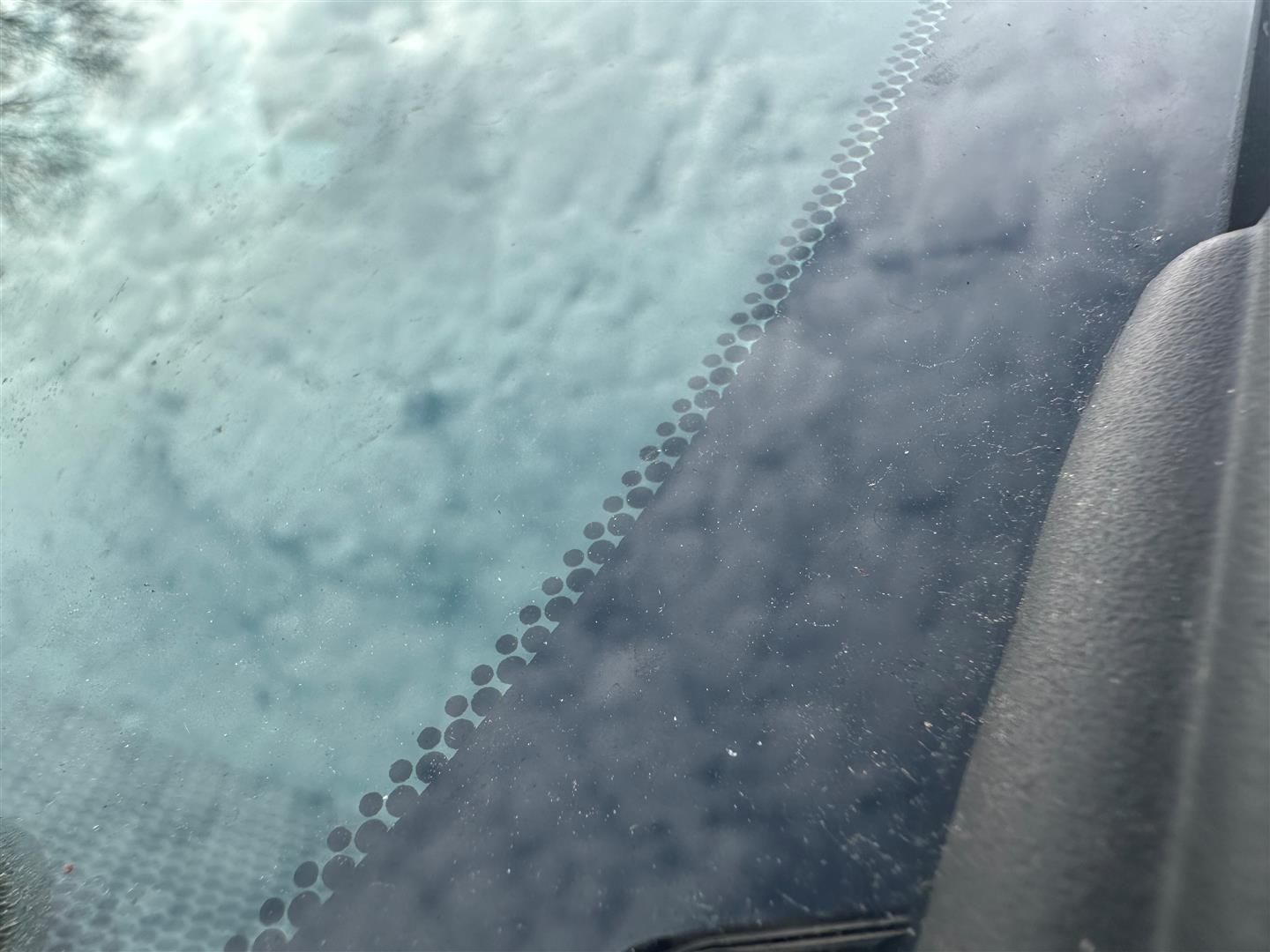 What Are Those Tiny Black Dots on Car Windows?