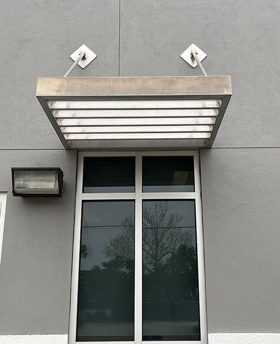 Metal awnings installed on commercial exteriors